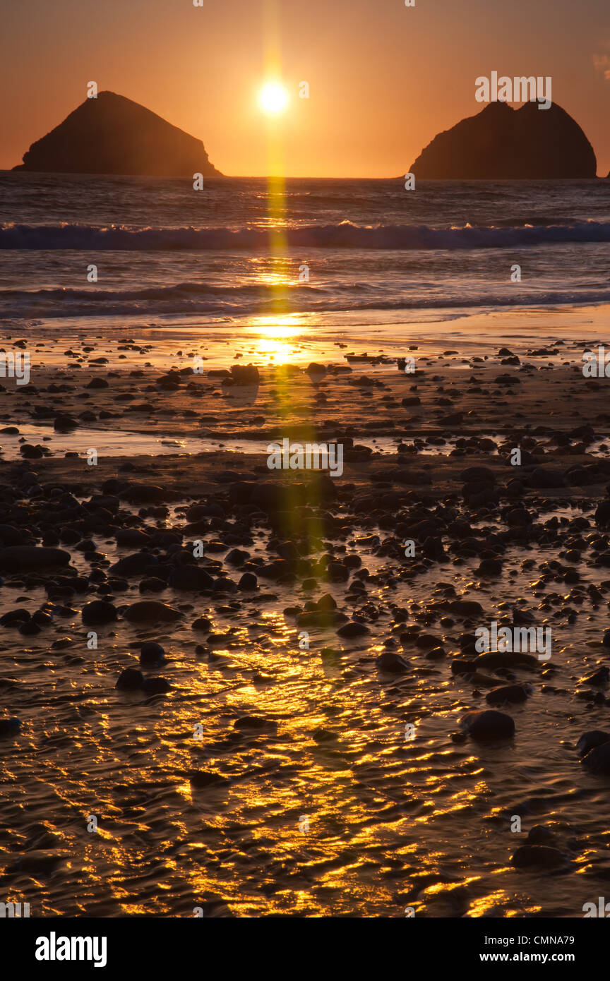 The spring sun sets between the sea stacks on the Oceanside Beach in ...