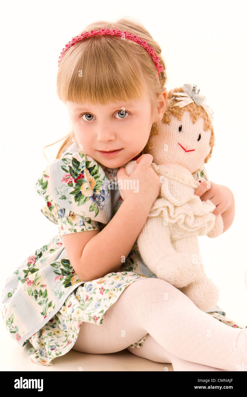 Portrait of happy little girl with a doll isolated on white Stock Photo ...