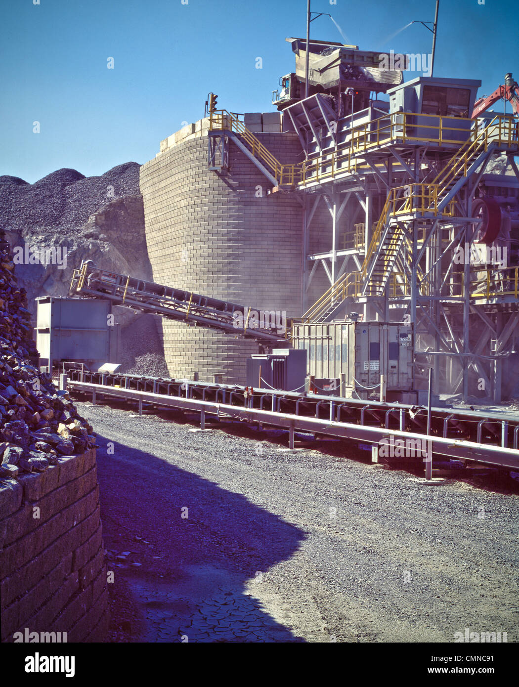 Cinder block wall in stone quarry. conveyor belt to crusher Stock Photo ...