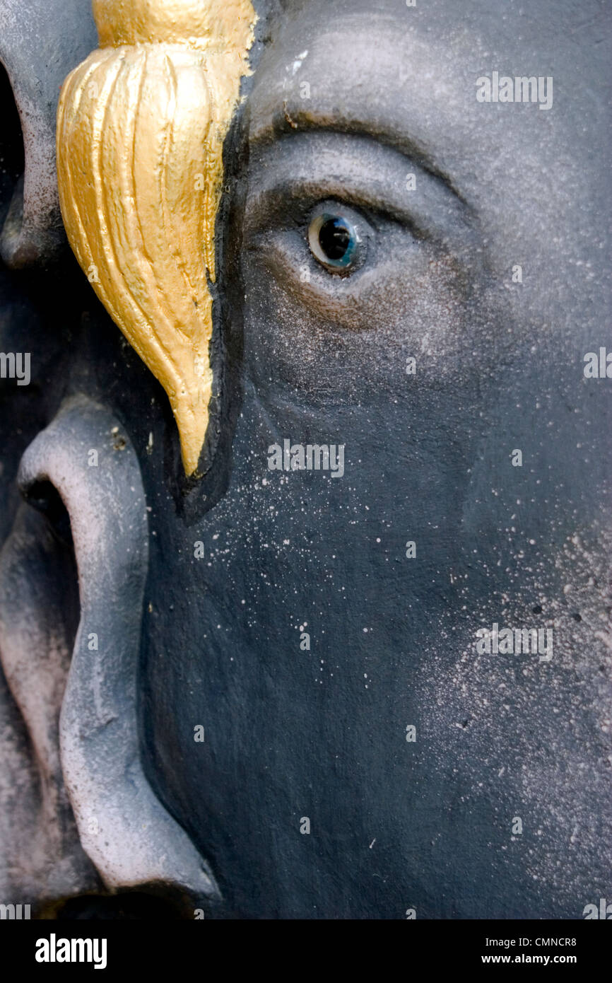 The eye of a large Buddhist elephant statue is on display at a temple ...