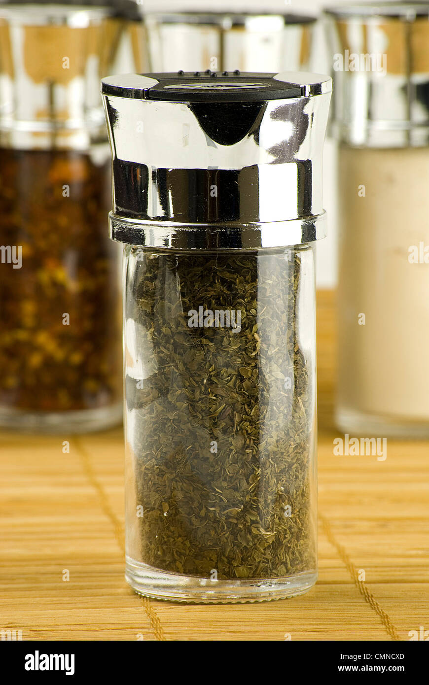 dry mint leaves in a glass jar on different spices background over ...