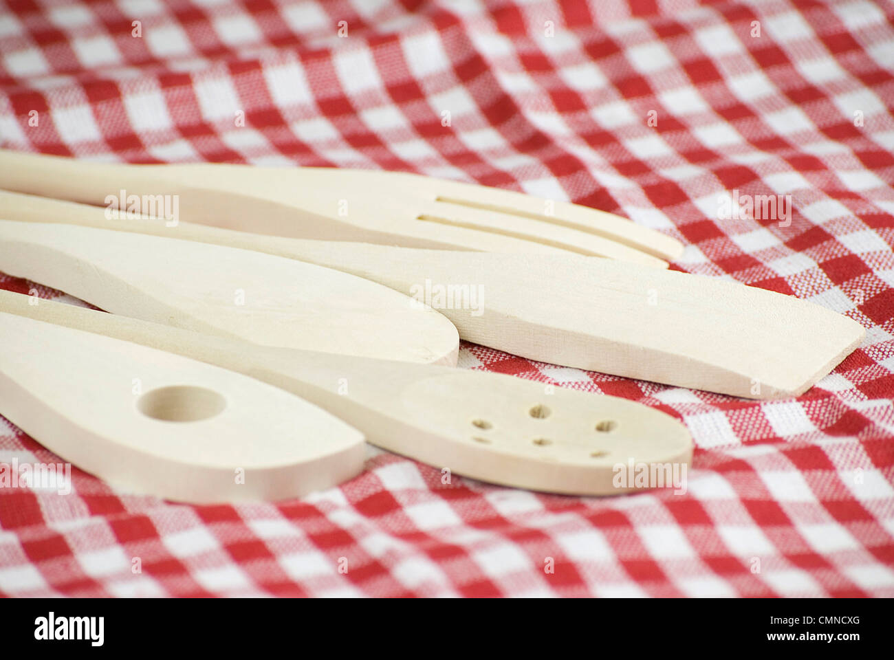 Wooden kitchen utensils over red and white cloth fabric Stock Photo - Alamy