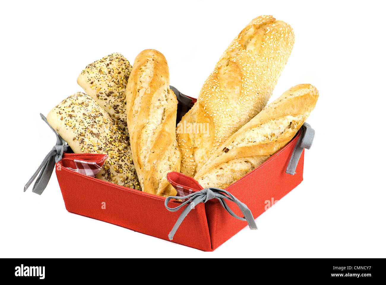 variety of different freshly baked bread in red cotton basket isolated ...