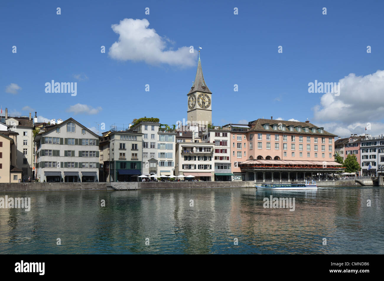 The River Limmat waterfront of Zurich with the spire of St. Peters ...