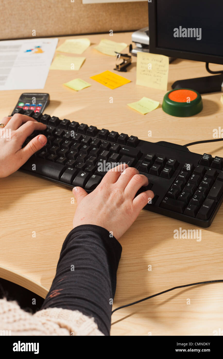 Office typing by a female worker Stock Photo - Alamy
