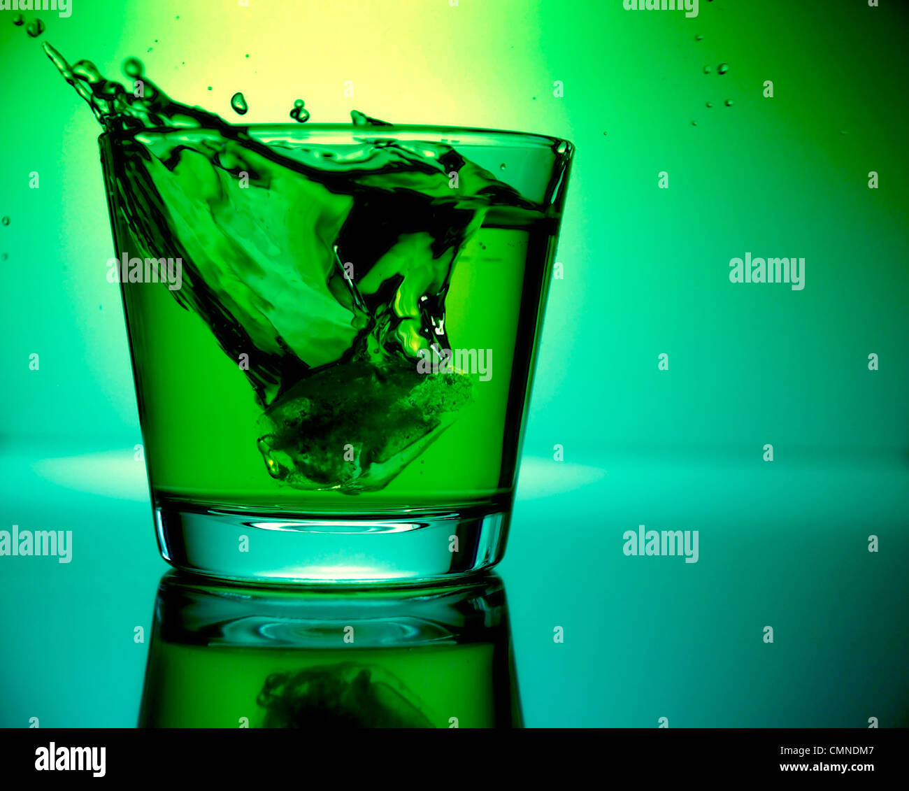 Colorful splashing drink with reflections Stock Photo - Alamy