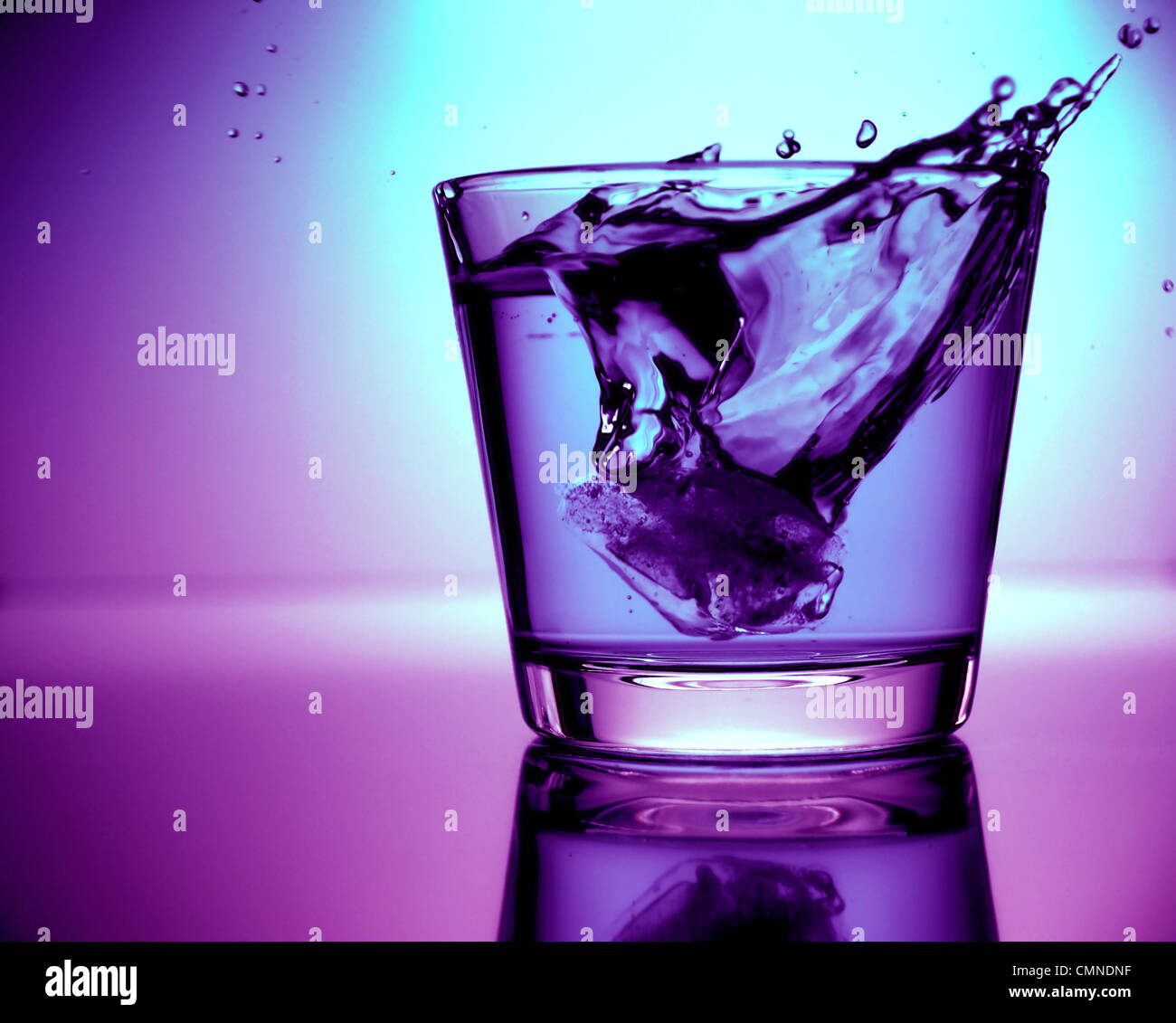 Colorful splashing drink with reflections Stock Photo - Alamy