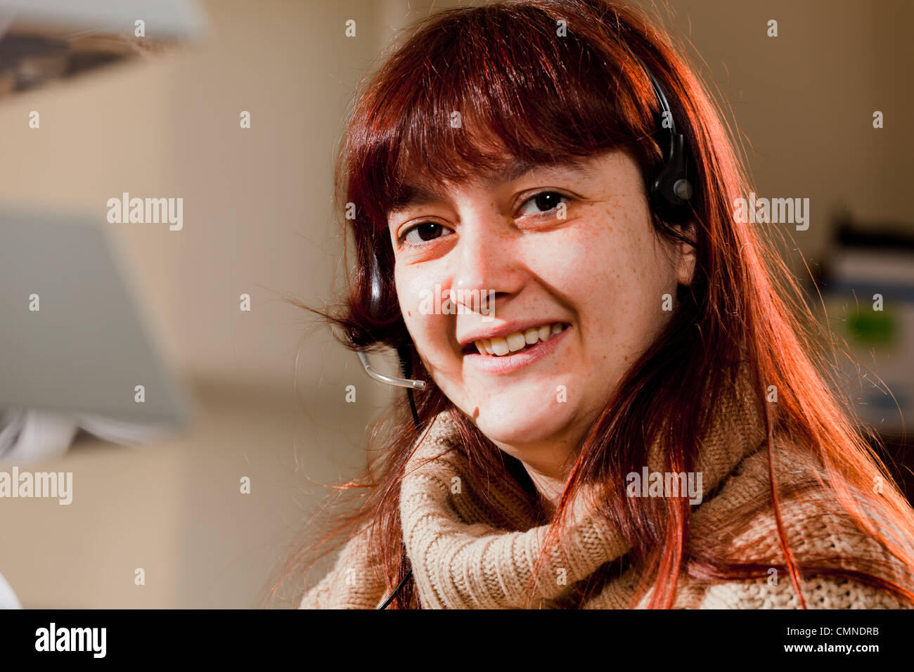 Friendly receptionist waiting for your call Stock Photo - Alamy
