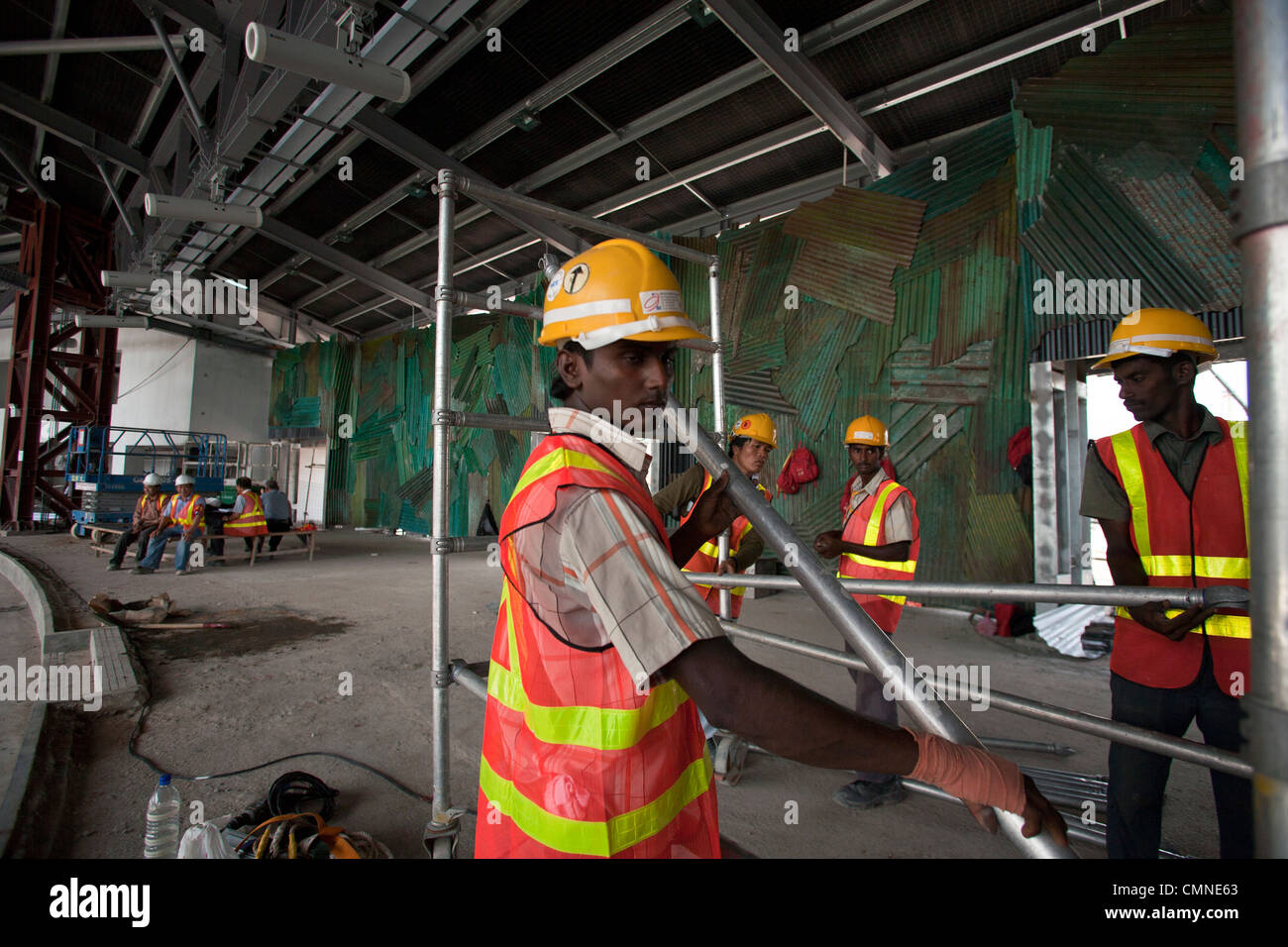 Migrant workers from South Asia work on the construction site of ...