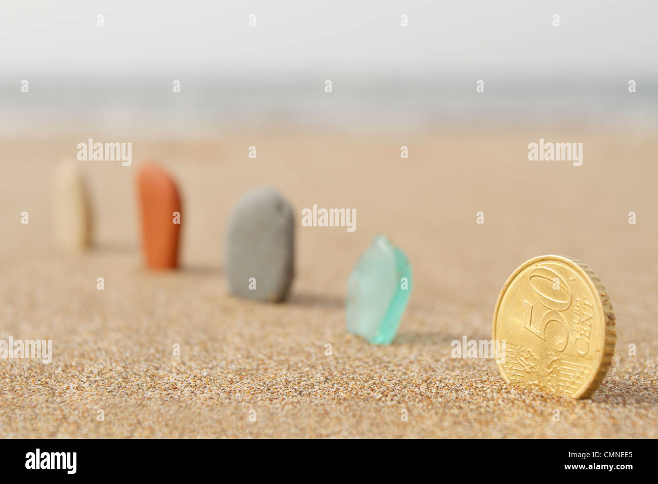 Pebbles and a gold coin indicating the path to return on investment ...