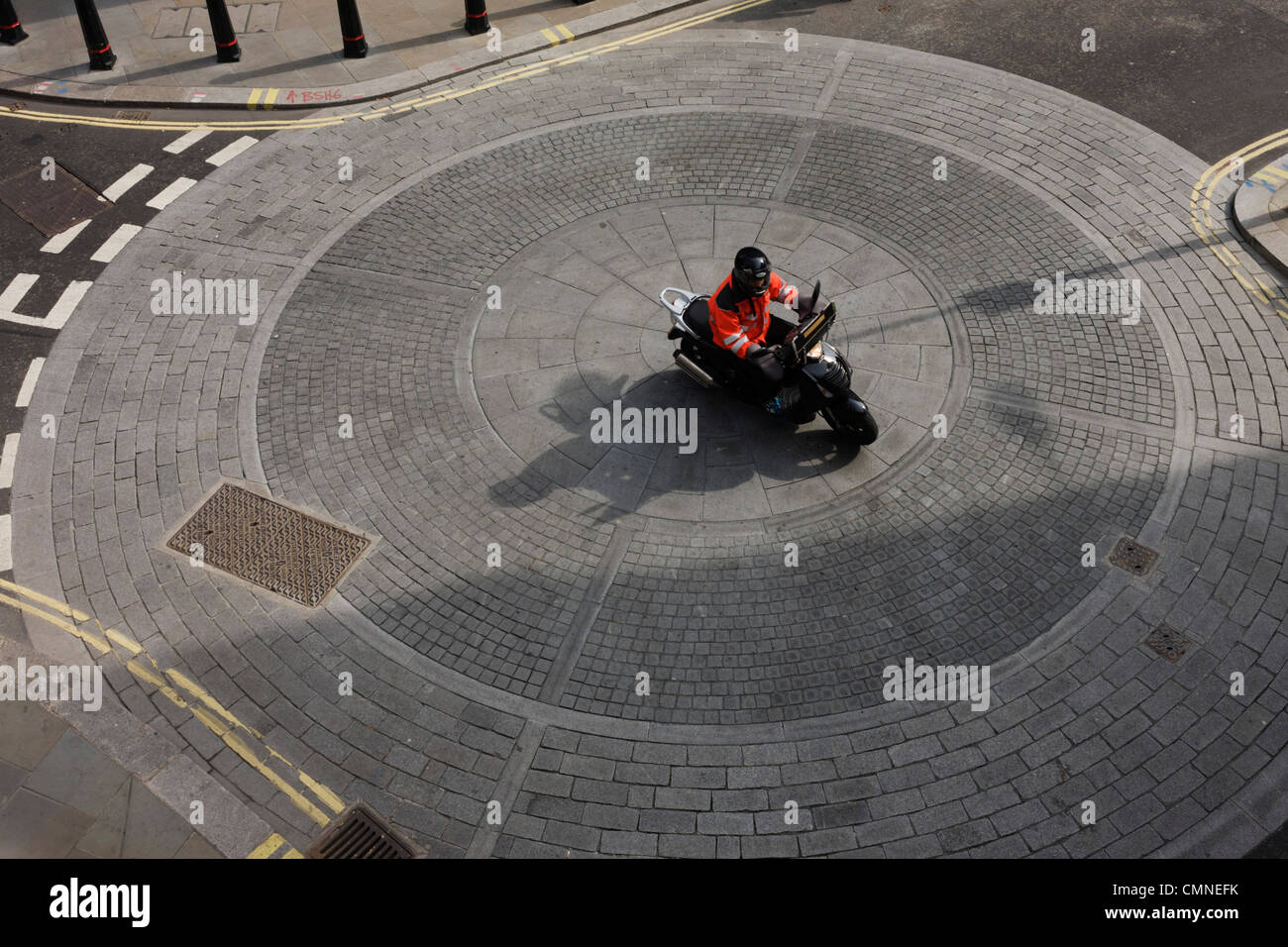 Aerial view of scooter bike rider as he crosses circles of a City of ...