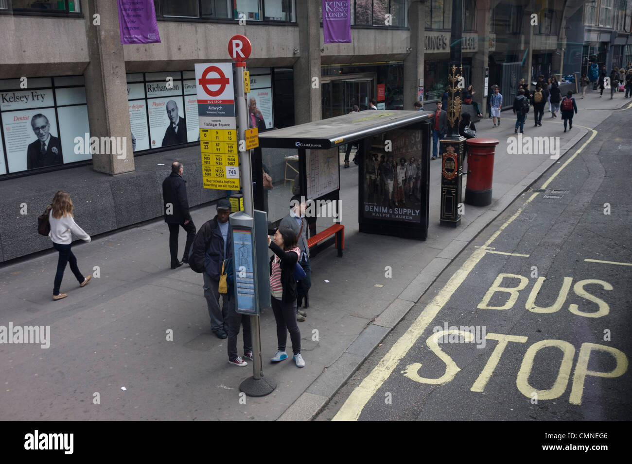 Aerial view of pedestrians and a city bus stop outside King's College ...