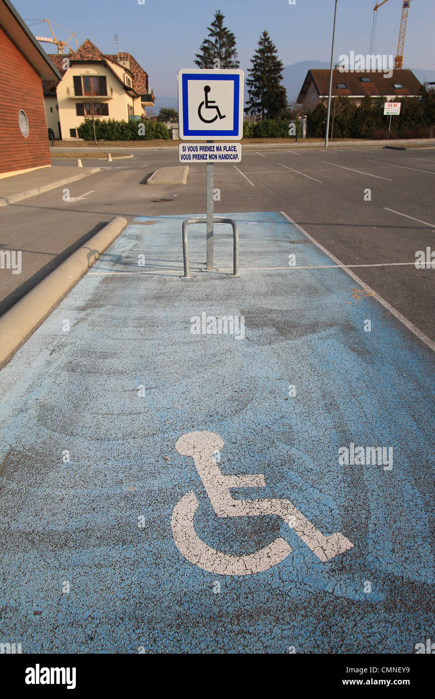 Blue parking space with icon for disabled persons Stock Photo - Alamy