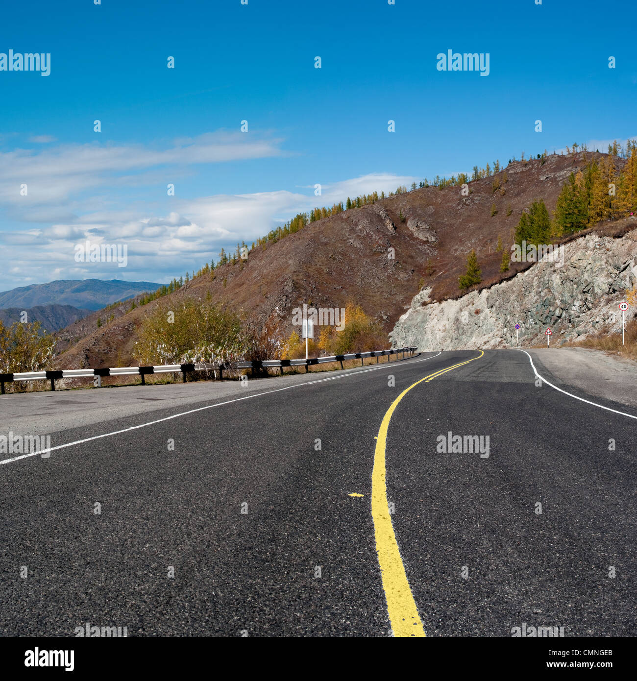 Empty mountain road with yellow marking Stock Photo - Alamy