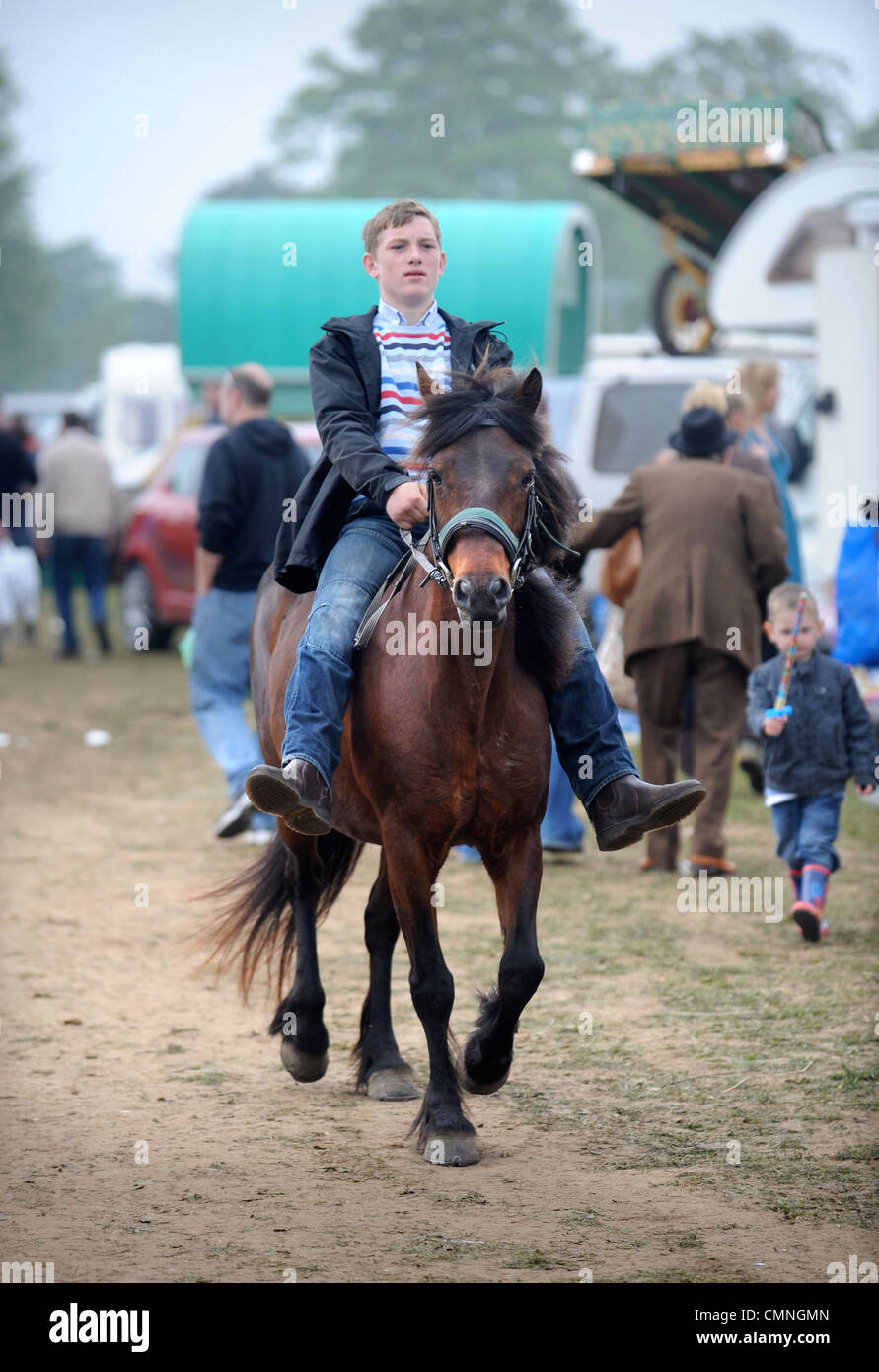 A boy riding a pony at the Stow-on-the-Wold horse fair May 2009 UK ...