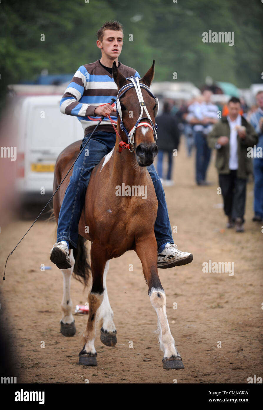 A boy riding a pony at the Stow-on-the-Wold horse fair May 2009 UK ...