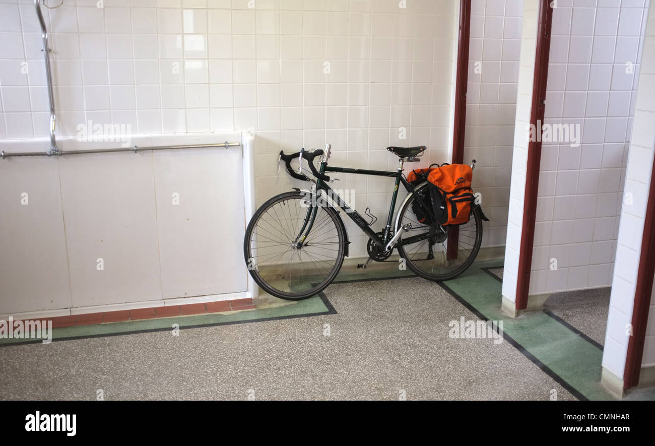 A bicycle propped up outside a cubicle in a public toilet Stock Photo ...