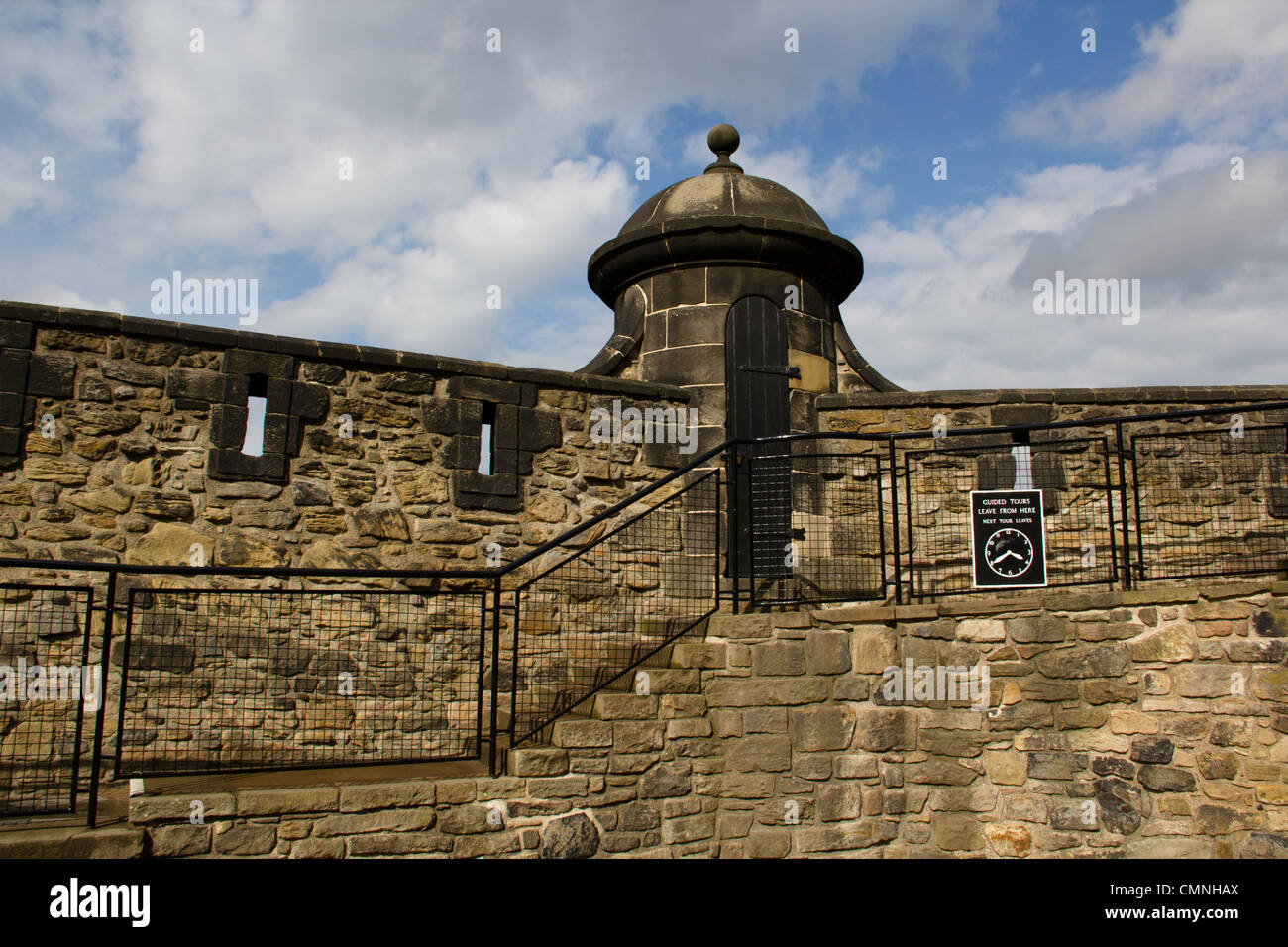 Upper section of Edinburgh Castle, with the stone wall, metal fence and ...