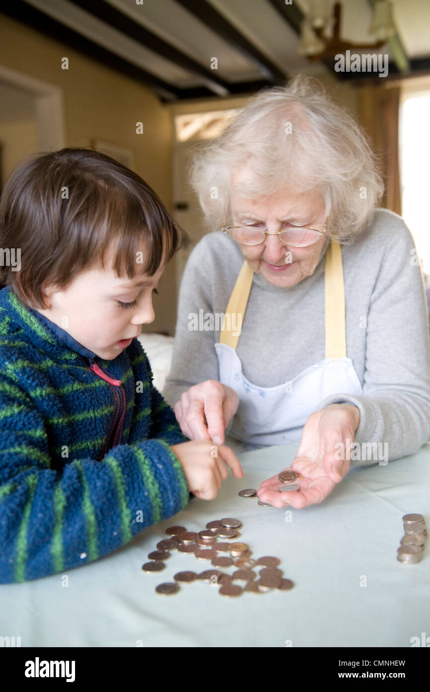grandma and grandson counting coins at dining table Stock Photo - Alamy