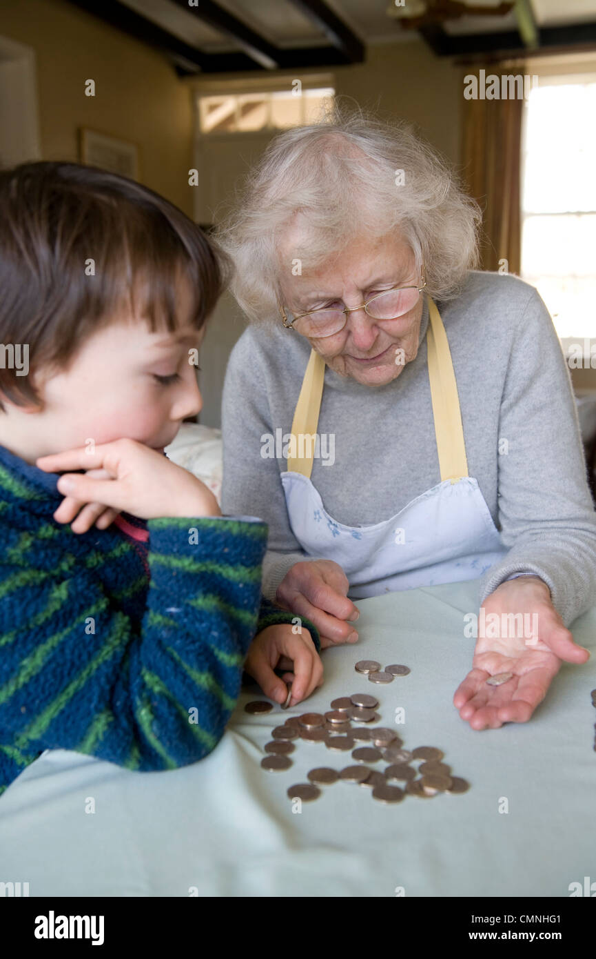 grandma and grandson counting coins at dining table Stock Photo - Alamy