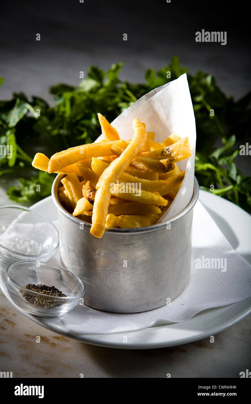 French fries served in aluminium pot with salad on side Stock Photo - Alamy