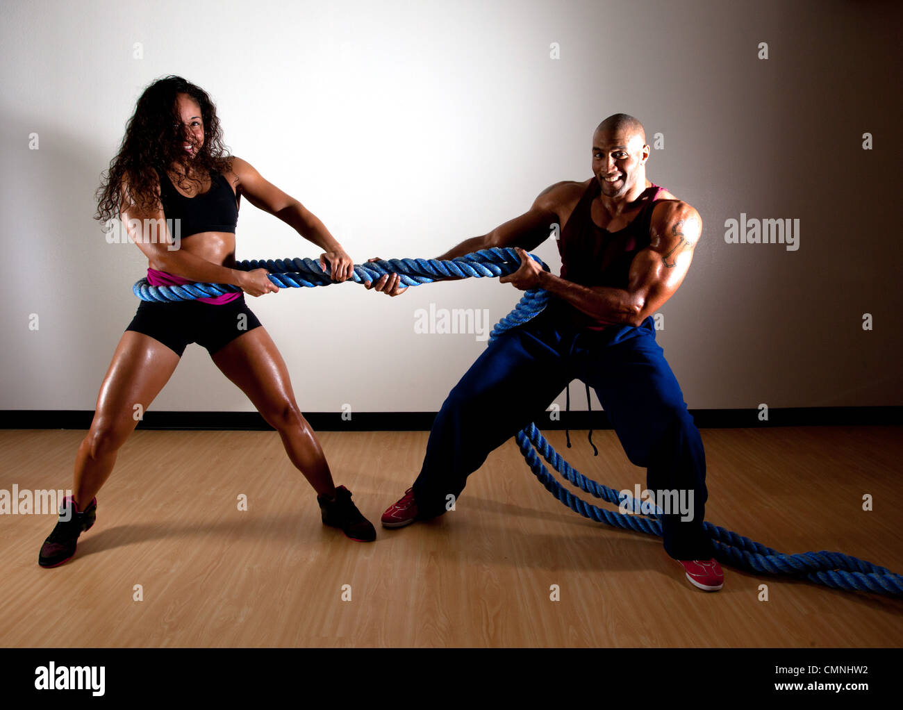 Young Latino Man and Woman Working out in a Gym Together Stock Photo ...