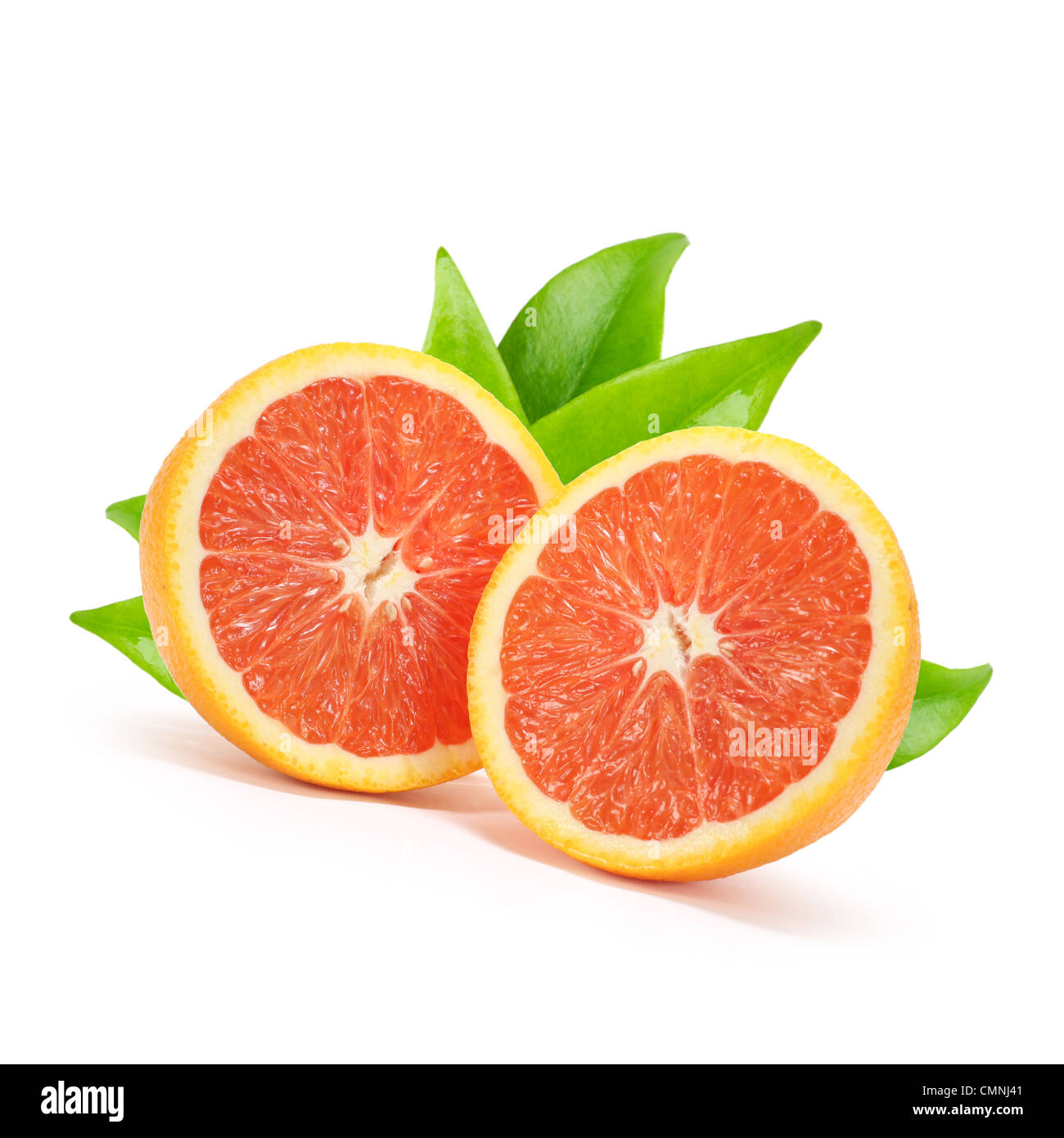 Two orange halves with leaves isolated on white Stock Photo - Alamy