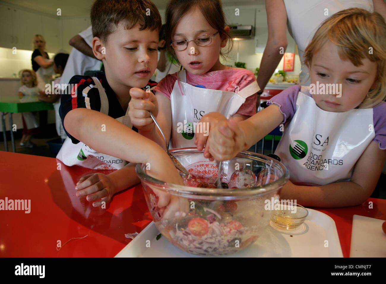 Children learning to cook fresh food at the Food Standard's "Eat well ...