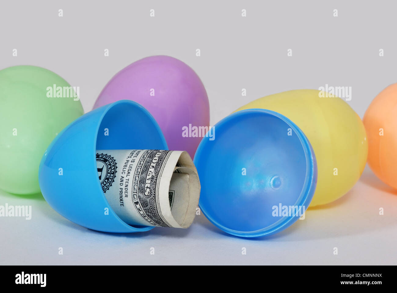 Colorful Easter eggs with cash hidden inside Stock Photo - Alamy