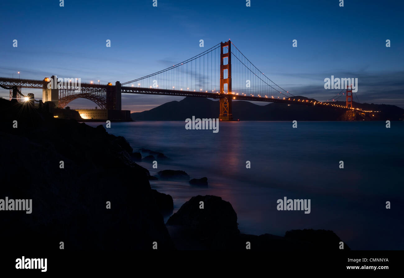 The Golden Gate Bridge near the Pacific Ocean at dusk in San Francisco ...