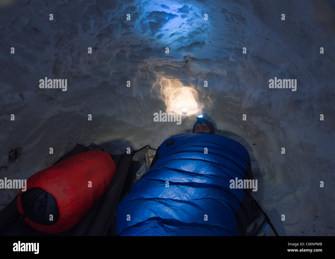 A man sleeping inside a snow cave Stock Photo - Alamy