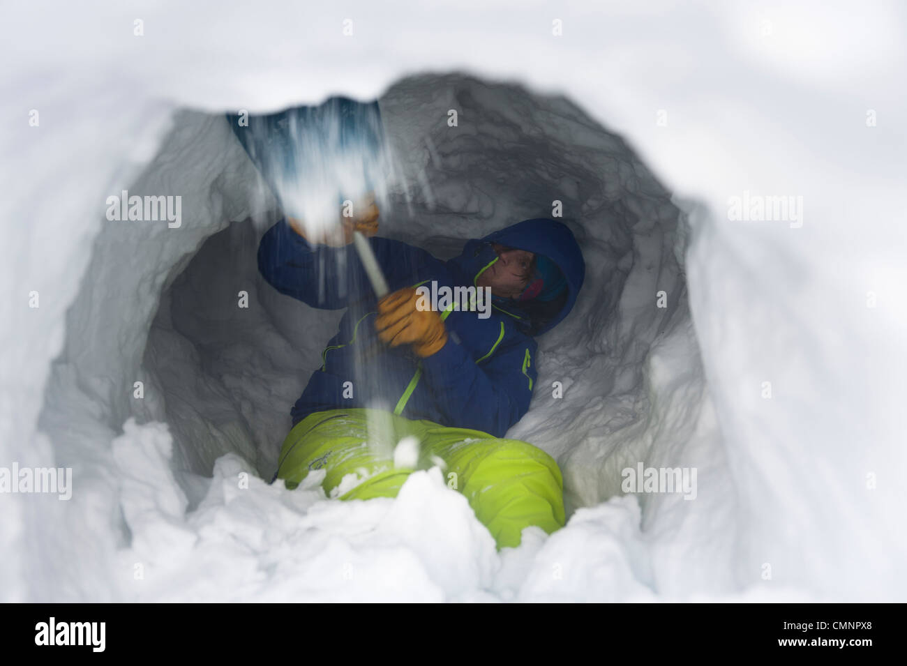 A man inside a snow cave Stock Photo - Alamy