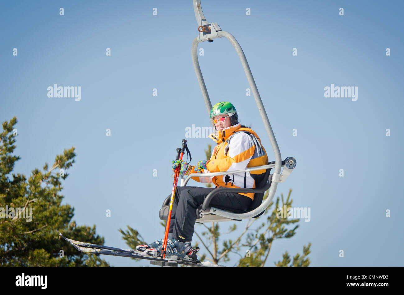Skier on chair lift Stock Photo - Alamy