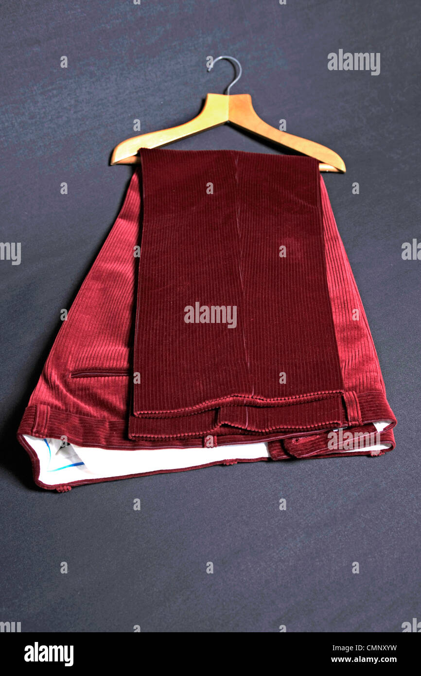 A pair of red corduroy men's pants on a black background Stock Photo ...