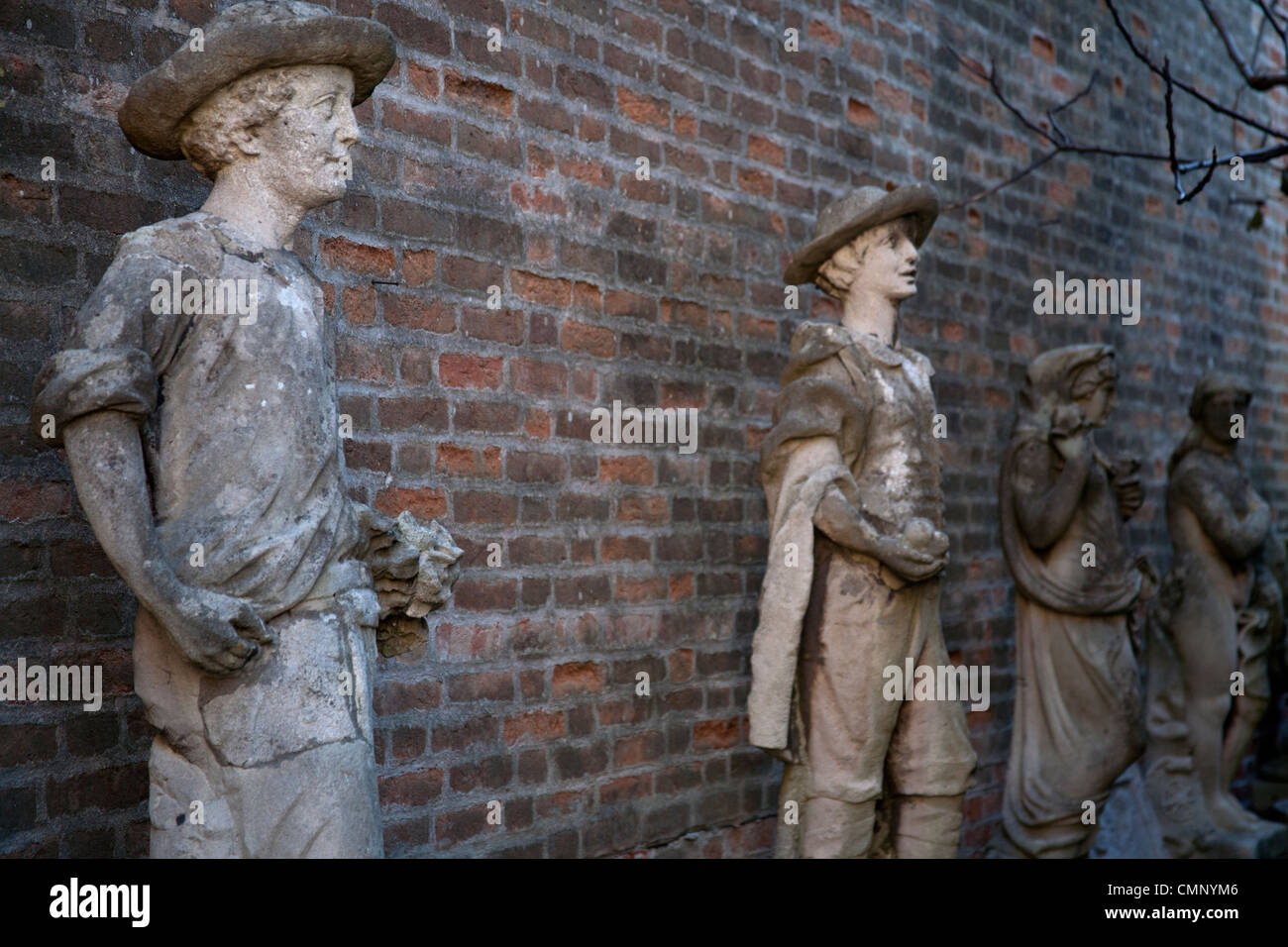 Statutes lined up against a brick wall in the garden of the Museo Di ...