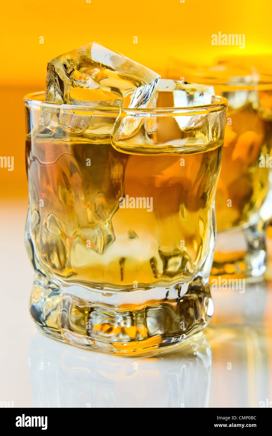 whisky with ice , focus on a foreground Stock Photo - Alamy