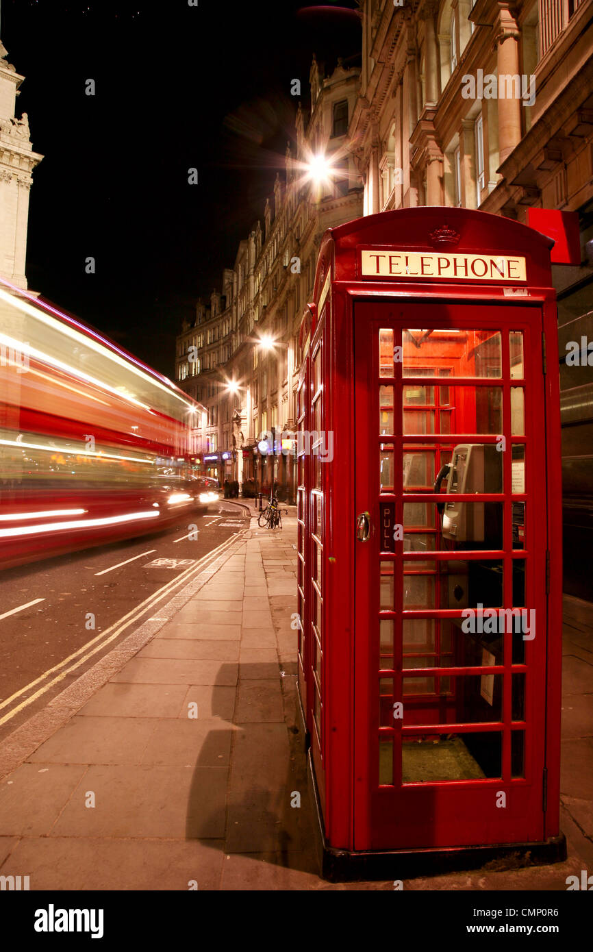 London Night View, bus lights rail passing over red telephone booth ...