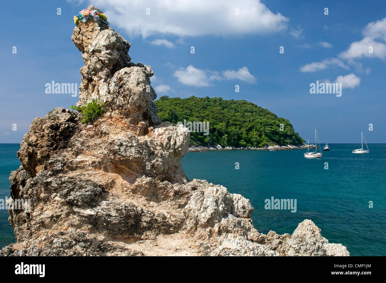 Craggy rock in a tranquil bay at the Southern coast of Phuket island ...