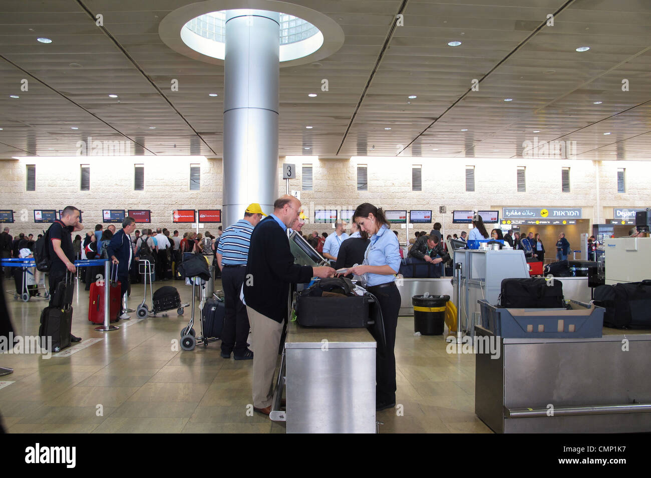 An Israeli security agent checks belongings of departing passengers at ...