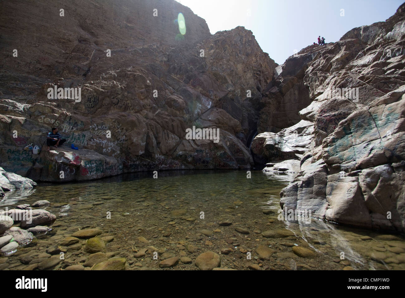 United Arab Emirates – Visitors explore the stunning rocky landscape of ...