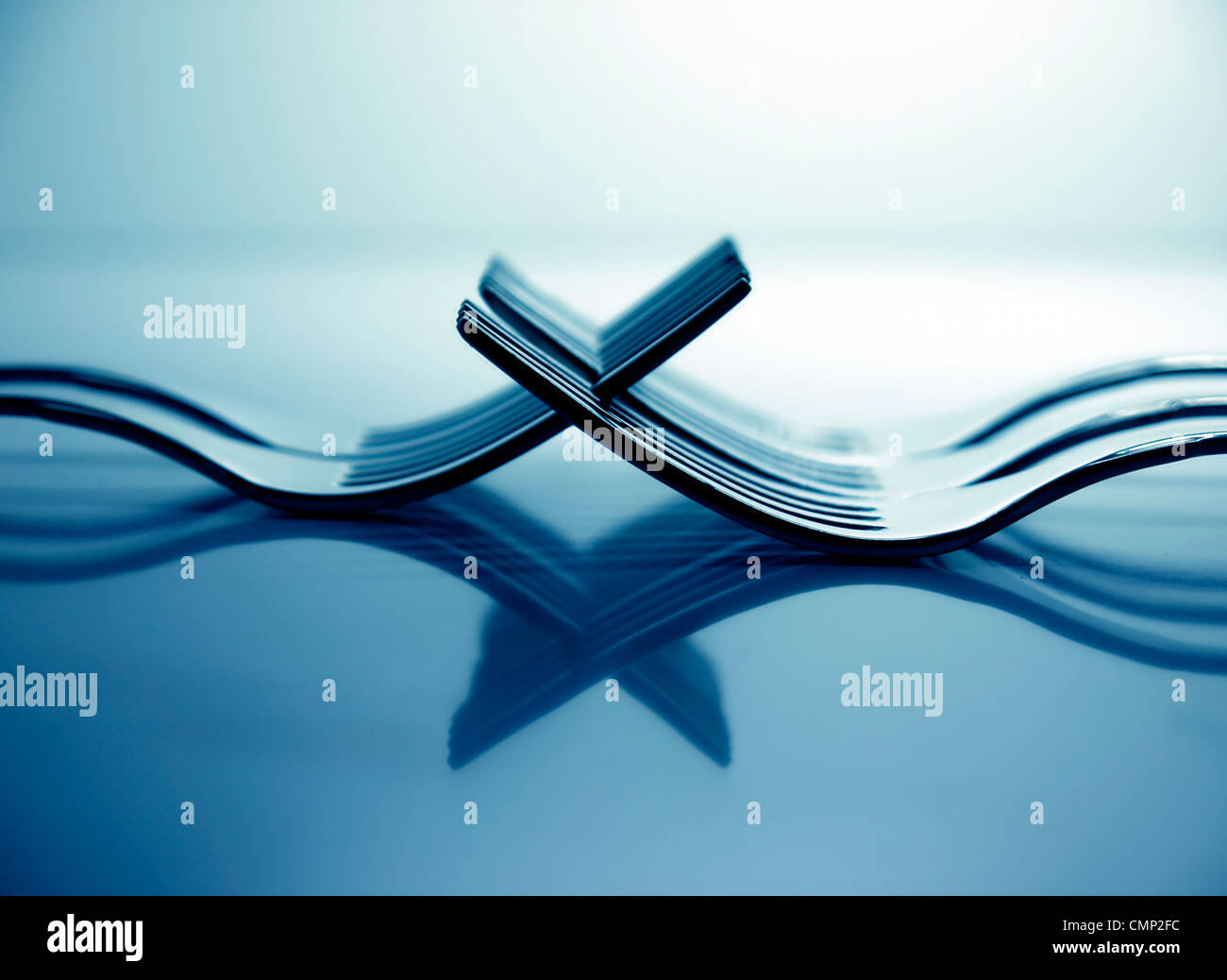 Blue forks with reflections Stock Photo - Alamy