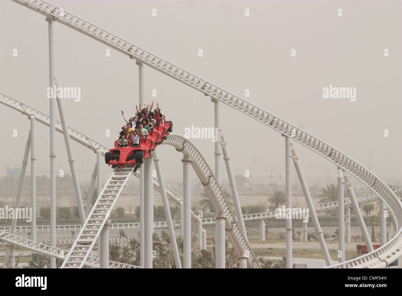 Thrillseekers with hands in the air ride the Formula Rossa, the world’s ...