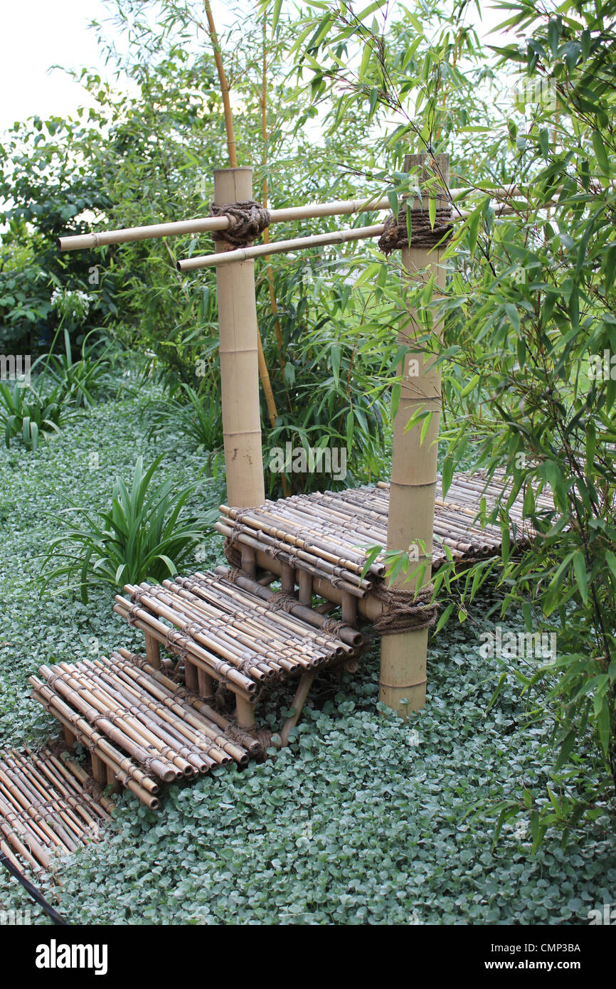 Little stairs leading to a bridge made of reeds and surrounded by deep ...