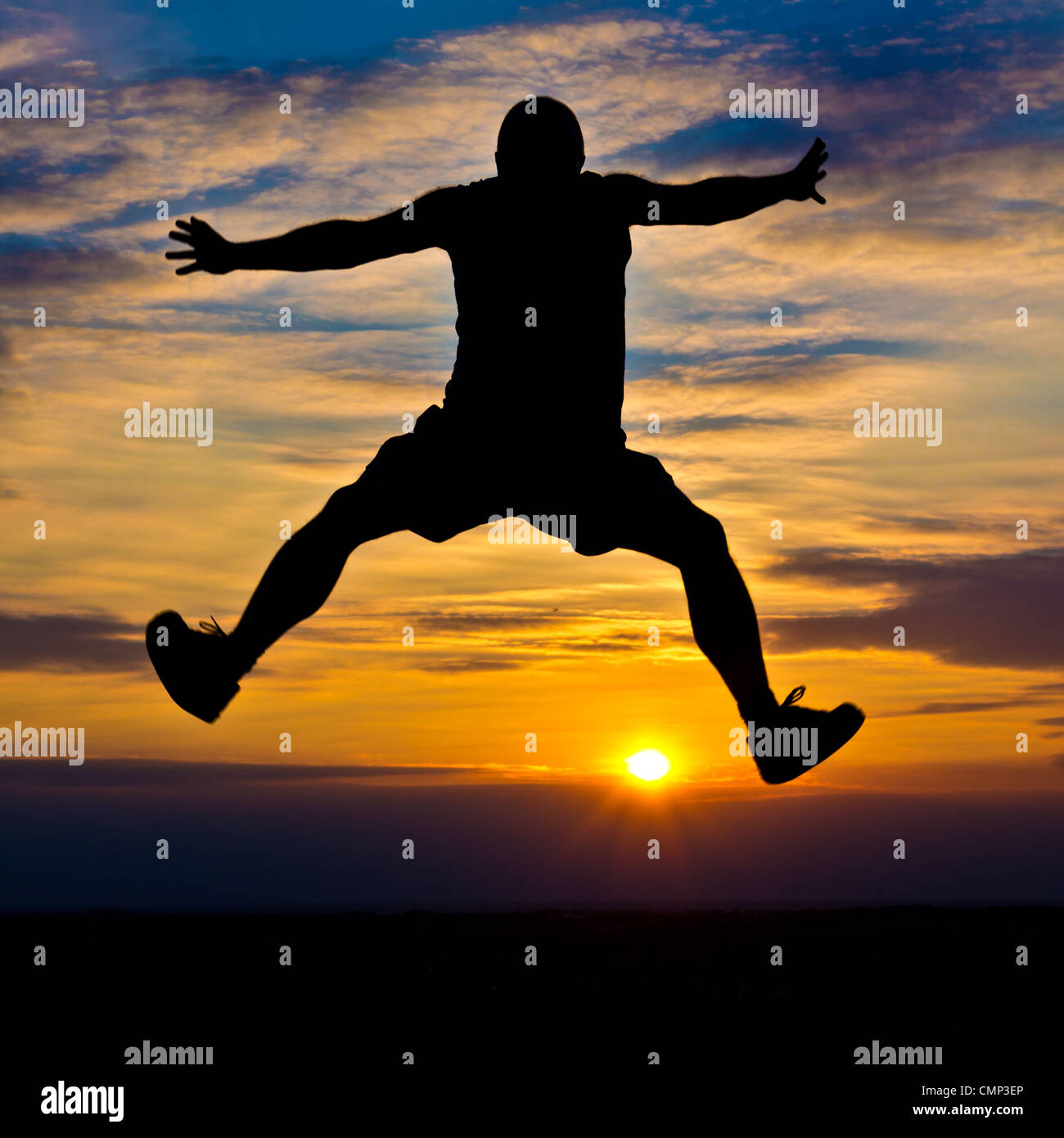 Man star jumps against sunset in silhouette Stock Photo - Alamy