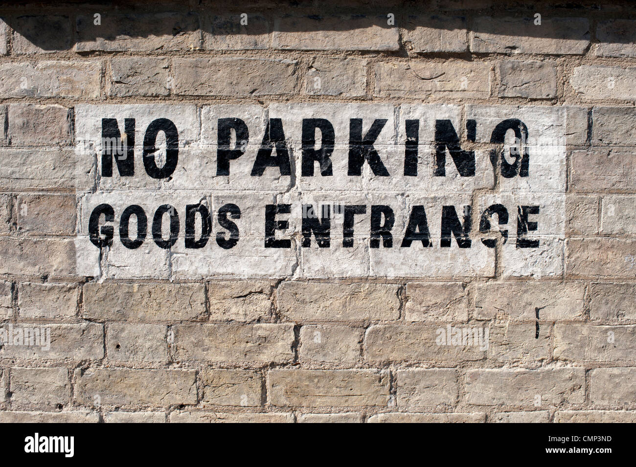 Old No Parking goods entrance sign painted on a wall in Cambridge UK ...