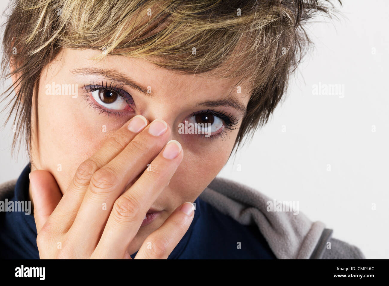 Painful looking young woman holding her hand to her face, female ...