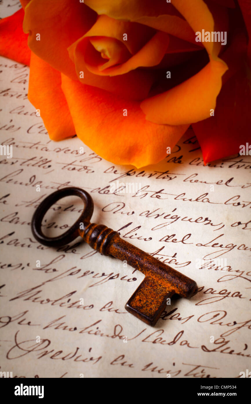 Old skeleton key on hand written letter with orange rose Stock Photo ...