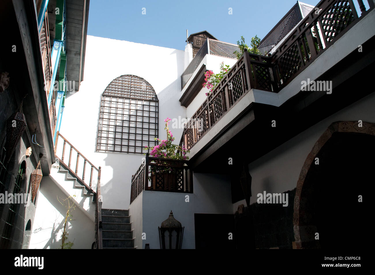 The open-air courtyard of a whitewashed traditional Arab Syrian home ...