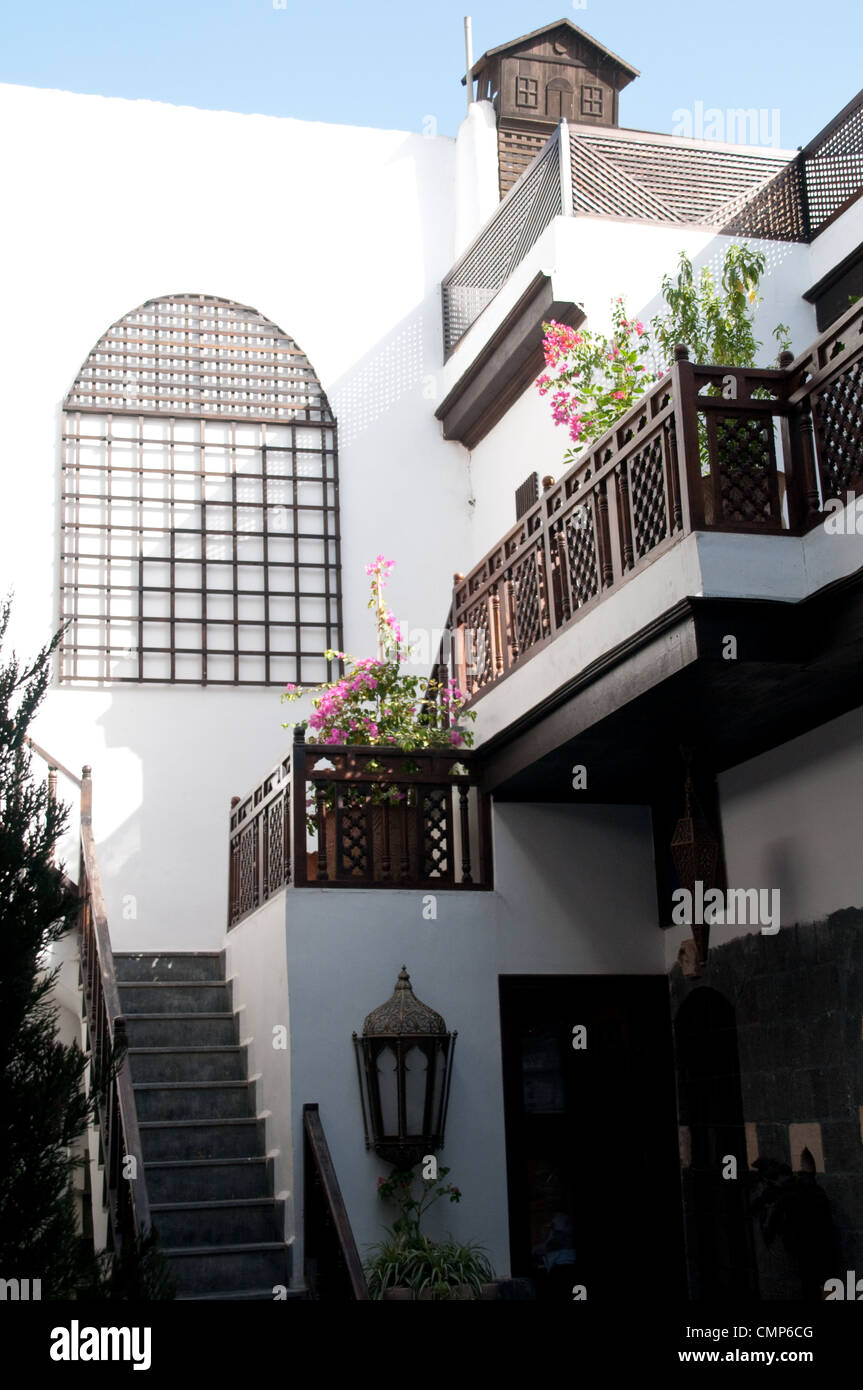 The open-air courtyard of a whitewashed traditional Arab Syrian home ...