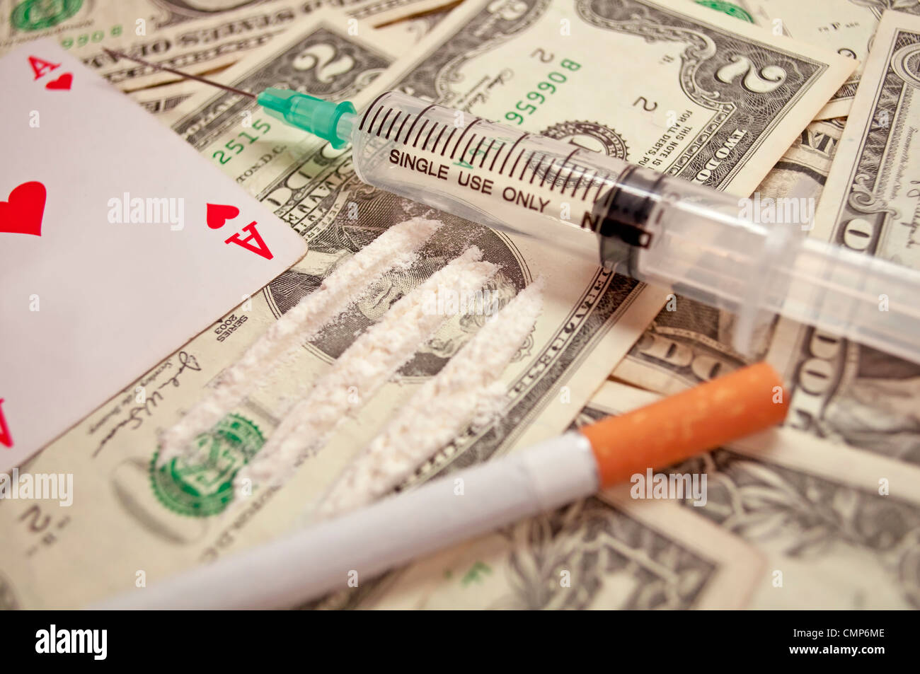 Conceptual image of addiction objects on money background Stock Photo ...